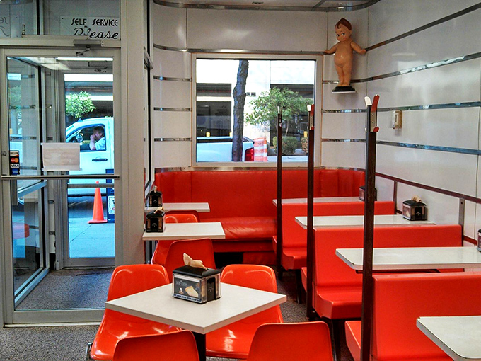 Inside, those cherry-red booths haven't changed in decades—and thank goodness for that. Some traditions deserve preservation, especially when they involve hamburgers.