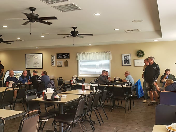Inside, ceiling fans lazily spin above a gathering of locals who know that the best conversations happen over plates of home-cooked goodness.