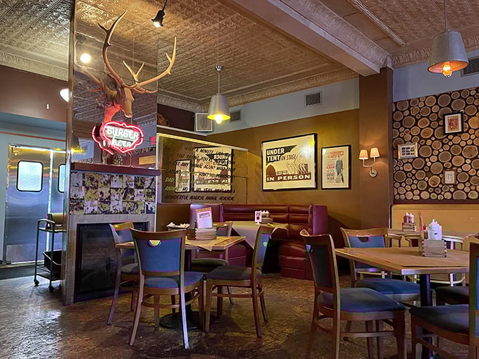 Rustic meets refined in this dining space where antlers and neon coexist peacefully. That wood-slice wall isn't just decoration&mdash;it's foreshadowing for the smoky delights to come.