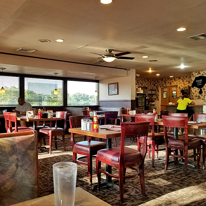 Classic red vinyl chairs and warm wood tables &ndash; the universal language of "sit down, relax, and prepare for comfort food that hugs your soul."