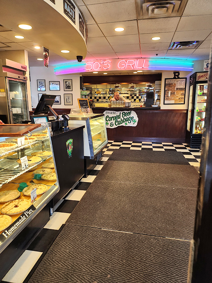 Step inside and the neon glow transports you instantly. The checkered floor and pie case aren't decoration&mdash;they're a promise that calories don't count in this particular dimension.