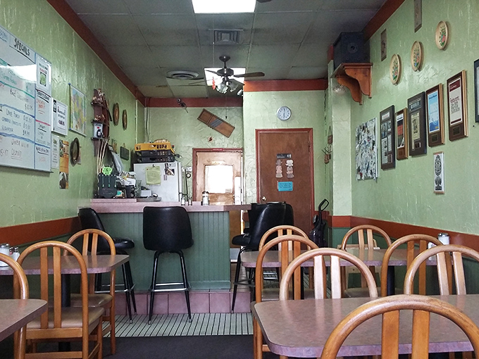 Step into a time capsule of comfort where mint green walls, wooden chairs, and decorative plates create the perfect backdrop for pierogi perfection.