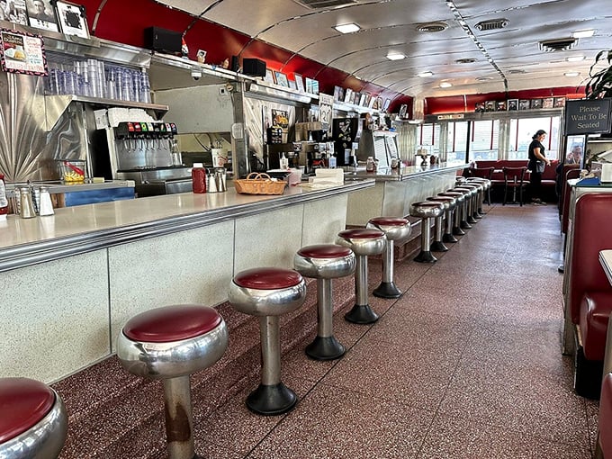 The counter culture is alive and well with these cherry-red stools lining up like excited guests. This isn't just seating; it's front-row tickets to the breakfast ballet.