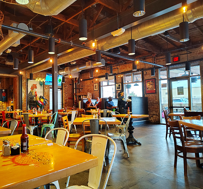 Industrial-chic meets Southern comfort in Lo-Lo's dining room. The exposed brick and ductwork create the perfect backdrop for the soul food drama about to unfold.