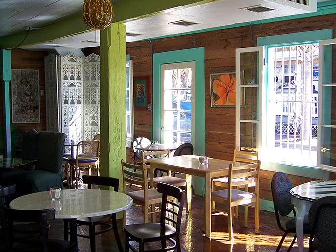 Sunshine streams through turquoise-trimmed windows, painting the mismatched furniture with that unmistakable Keys glow that makes time slow down.