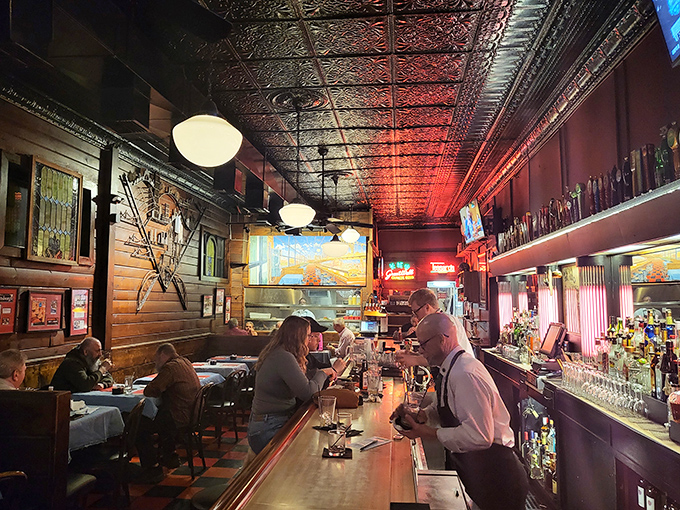 That pressed tin ceiling has witnessed countless first dates, celebrations, and the silent prayer of burger devotees about to receive their salvation.