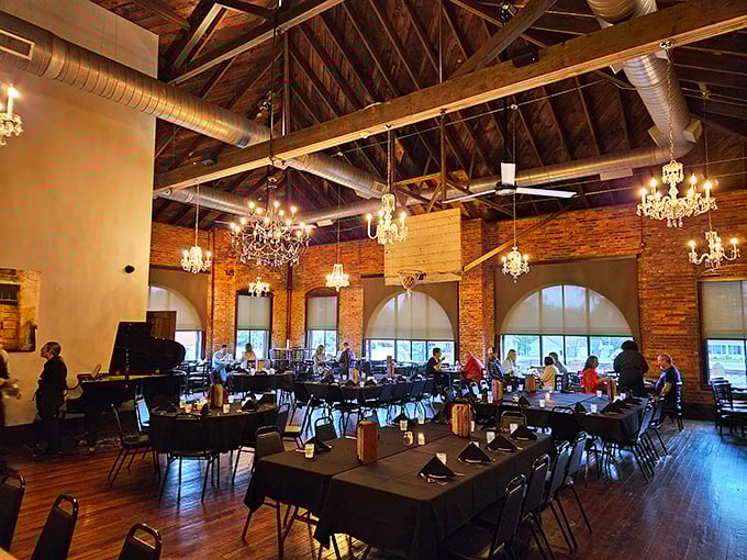 Exposed wooden beams meet crystal chandeliers in this stunning dining room, where rustic charm and elegance dance together beneath soaring ceilings.