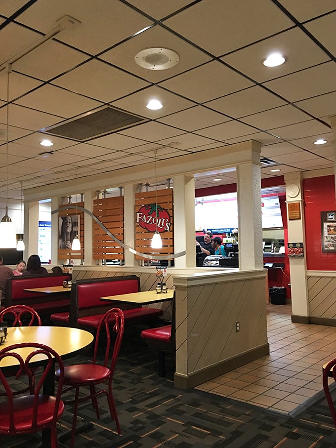 Inside, the practical charm of red booths and wooden dividers creates that sweet spot between fast-casual efficiency and sit-down comfort that keeps regulars coming back.