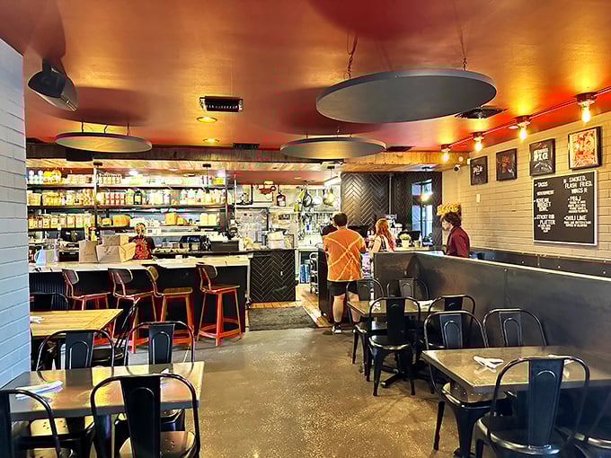 Industrial-chic meets barbecue warmth inside, where the copper ceiling glows like the embers that smoke their legendary meats.