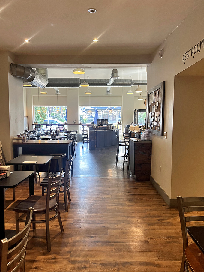 Inside, warm wooden floors meet industrial-chic exposed ductwork, creating a space that says "stay awhile" without saying a word.