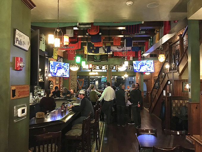 Where flags from around the world hang like colorful sentinels above patrons enjoying that perfect balance of lively conversation and cozy comfort.