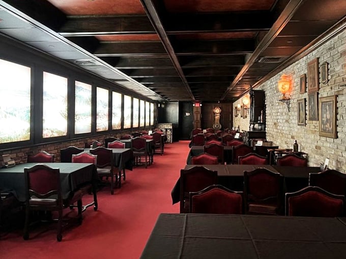 Red carpets and stone walls create an atmosphere that whispers, "Tonight is special." This dining room has witnessed more celebrations than a calendar factory.