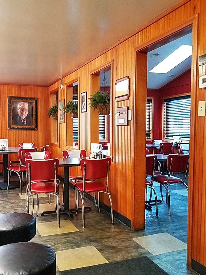 Classic red vinyl chairs and wood-paneled walls create the perfect time capsule. This isn't retro by design—it's authentic by persistence.