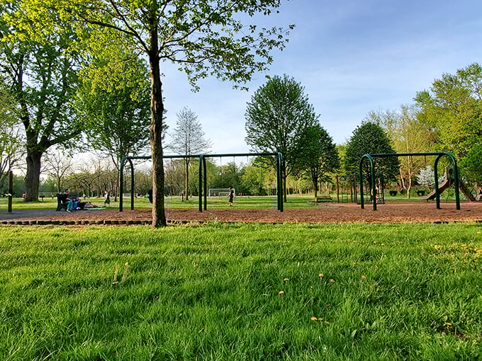 Playground philosophy: While kids see swings and slides, parents see fifteen minutes of peace and an excellent coffee-drinking bench.