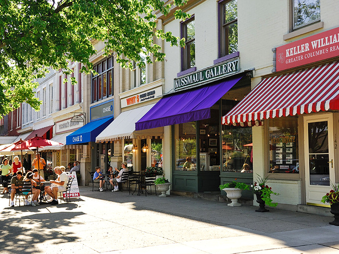 Colorful awnings create a patchwork of shade where locals gather, proving that the best social network has always been a small-town sidewalk.