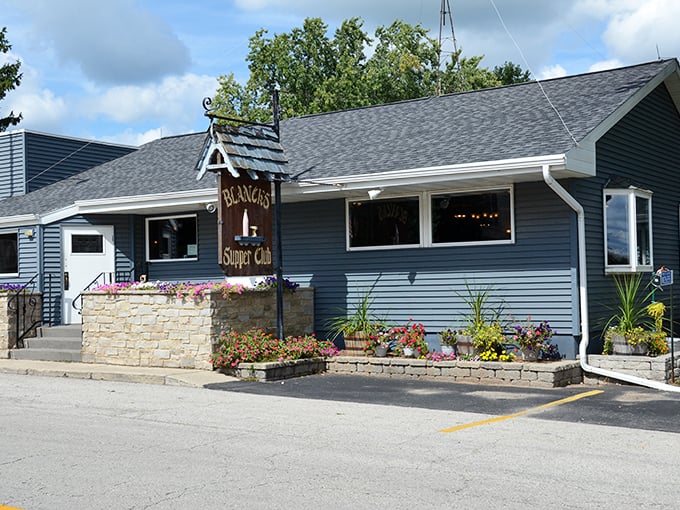 Blue-sided and flower-decked, this supper club's modest exterior hides Wisconsin's temple to perfect beef.