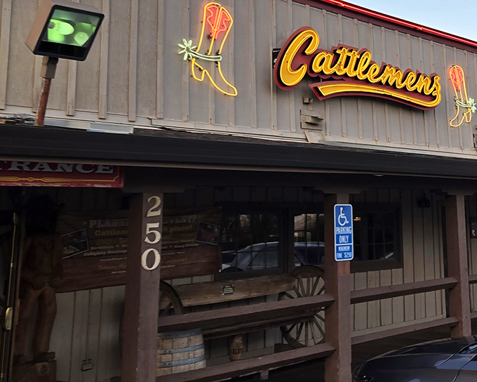 The neon cowboy boot sign at Cattlemen's glows like a beacon for weary travelers with empty stomachs and dreams of ribeye.