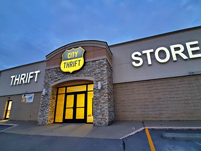 City Thrift's stone-accented entrance glows like a beacon at dusk. The shield logo hints at the bargain battles waiting inside.