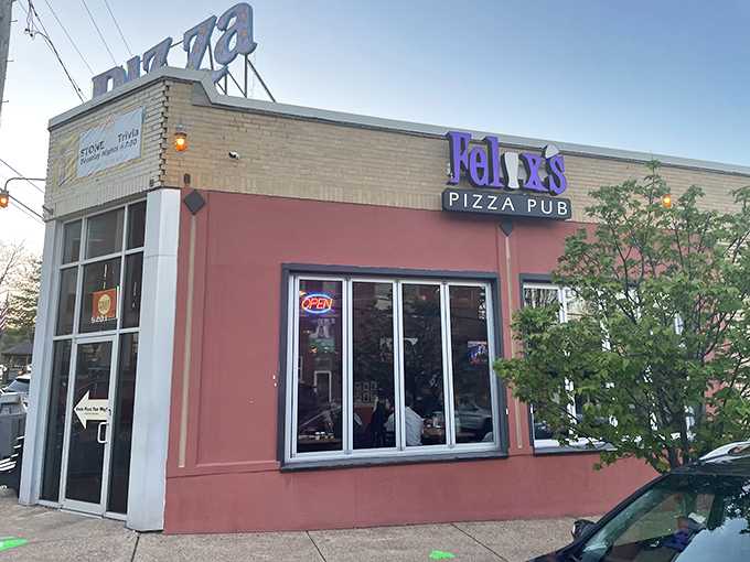 Purple signage pops against urban brick, marking where St. Louis locals gather for their neighborhood pizza ritual.