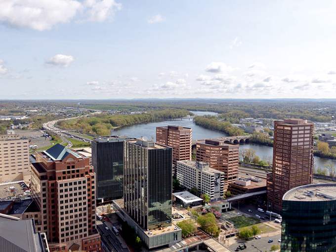 Hartford's riverside skyline gleams in the sunshine, with the Connecticut River curving gracefully through the capital city.
