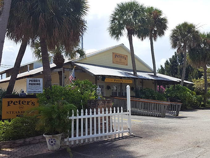 Peter's Steakhouse nestles among swaying palms, a charming Old Florida cottage promising beef-filled bliss behind that white picket fence.
