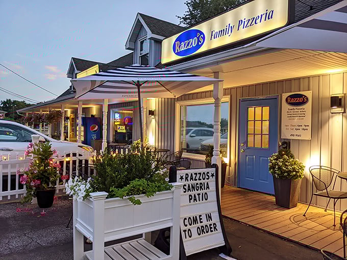 Razzo's charming cottage-like exterior feels like you've stumbled upon a secret pizza sanctuary at twilight.