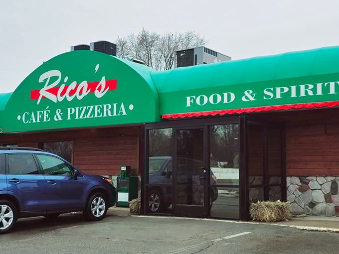 Green awning, big promises! Rico's modest exterior hides pizza treasures waiting to be discovered.