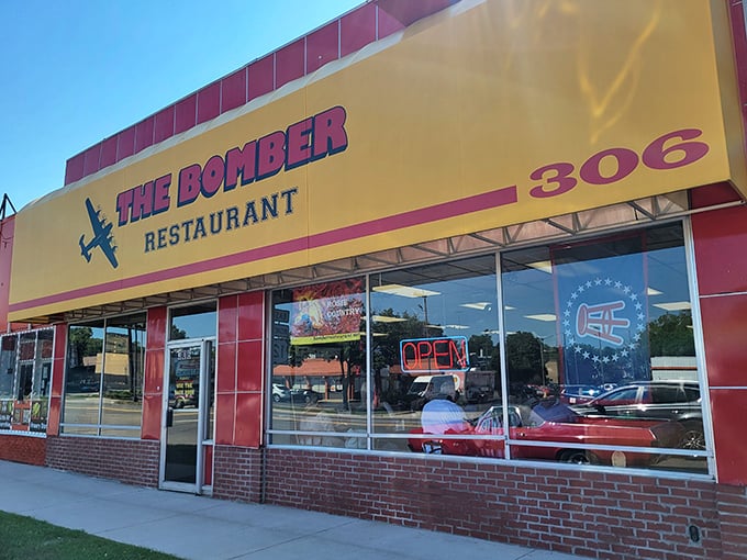 The Bomber's bold yellow sign promises comfort food with a side of aviation history. No flight plan needed!