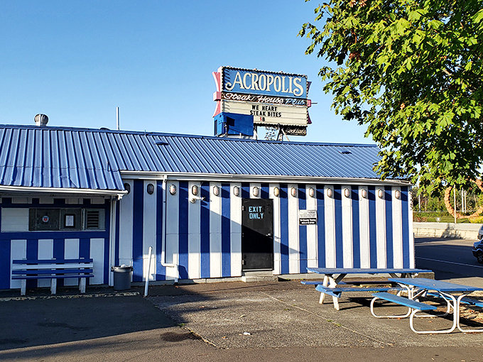 This unassuming blue-striped building houses steaks that would make Zeus himself descend from Mount Olympus for a taste.
