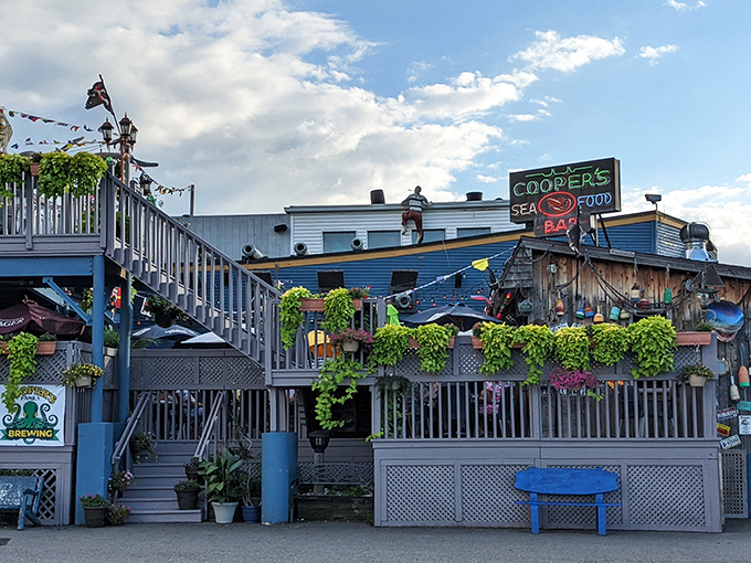 The deck at Cooper's feels like a coastal getaway, where summer nights, string lights, and seafood create vacation vibes.
