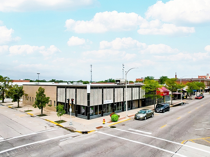 Explore the charming streetscape of Grand Island, Nebraska, featuring local businesses and peaceful city views on a lovely sunny day.