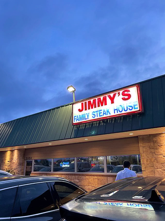 As evening falls, Jimmy's glowing sign becomes a beacon for hungry travelers seeking honest-to-goodness steak perfection.