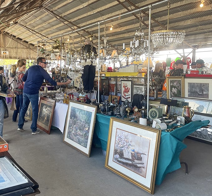 Crystal chandeliers hang above a sea of antiques, creating an elegant backdrop for serious treasure hunting.