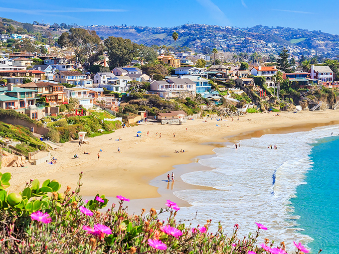 Pink flowers frame Laguna's golden sand and turquoise waters—Mother Nature showing off her color coordination skills.