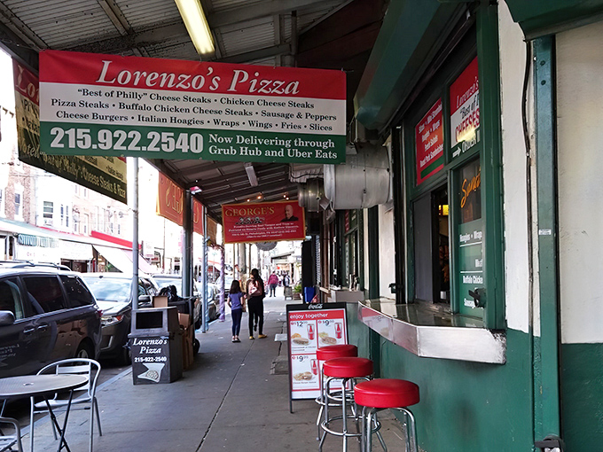The sidewalk seating at Lorenzo's isn't fancy, but who needs fancy when you've got pizza slices bigger than your face?