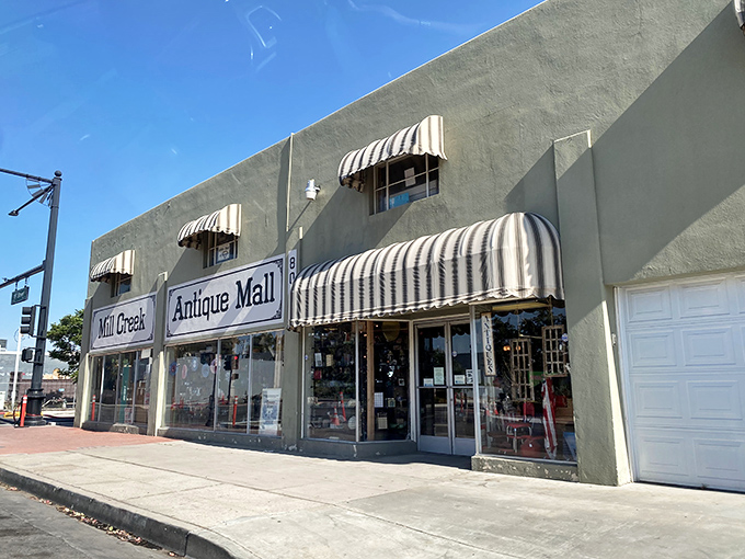 The soft green exterior of Mill Creek Antique Mall beckons collectors like a siren song for vintage enthusiasts.