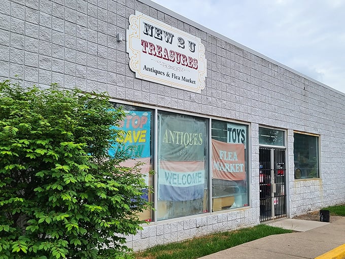 Colorful banners welcome treasure hunters to this indoor paradise where antiques and collectibles create their own magical neighborhood.