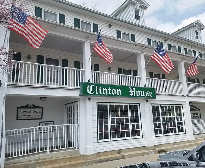 American flags flutter above the Clinton House like a patriotic welcome committee. History and hospitality in perfect harmony.