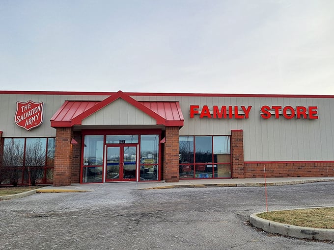 Red signage pops against clean white walls - a thrift store that understands presentation is half the battle!