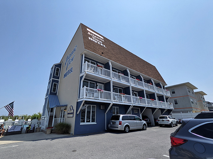 The Atlantic View Hotel stands ready for weary beach-goers, its blue-and-white charm promising ocean breezes and vacation dreams.