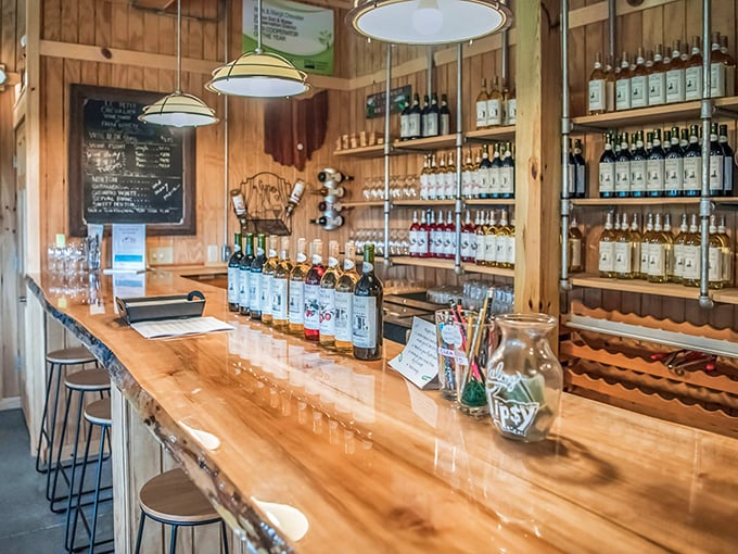 Behind this live-edge wooden bar, liquid happiness awaits. The pendant lights cast a warm glow that makes every sip feel like a special occasion.