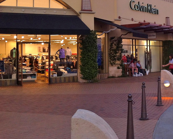 Calvin Klein's storefront glows with promise as evening shoppers hunt for deals that would make their wallets and wardrobes equally happy.