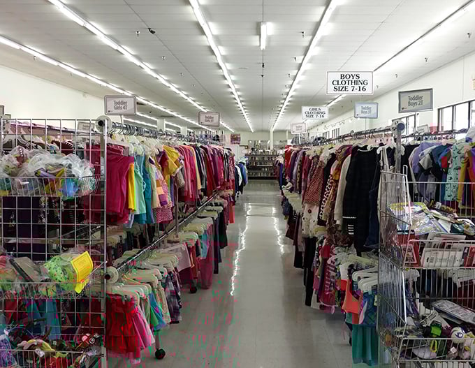 A rainbow of possibilities stretches down the clothing aisle. Each garment holds stories from its past life, waiting for you to write the next chapter.