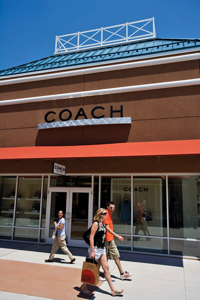 The Coach mothership has landed! Shoppers emerge victorious, branded bags in hand &ndash; proof they've conquered the mountain of luxury at molehill prices.