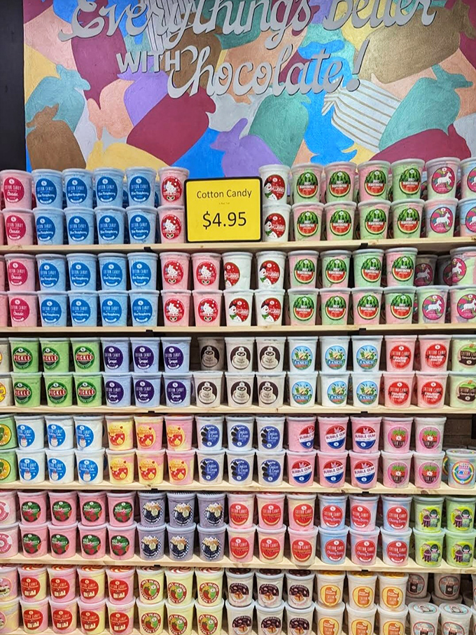 "Everything's Better with Chocolate!" proclaims the wall behind this rainbow of cotton candy containers. A chromatic symphony of sweetness awaits.