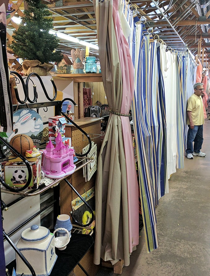 A rainbow of fabric possibilities hangs alongside whimsical toys and household treasures, proving everything old becomes new again.