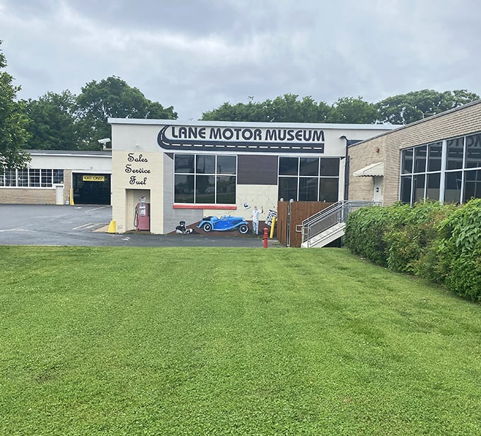 The vintage gas pump and painted car mural offer just a tiny appetizer of the mechanical feast waiting inside this automotive wonderland.