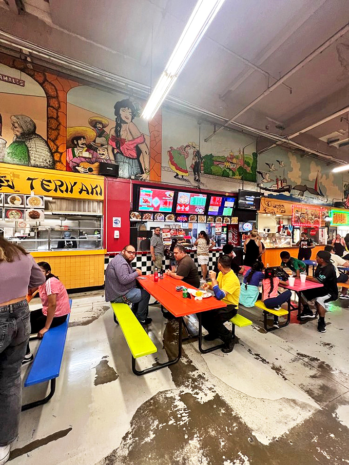 The food court: where vibrant murals watch over hungry shoppers, colorful picnic tables invite lingering conversations, and teriyaki meets tacos in delicious harmony.