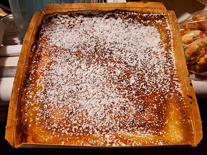 Behold the holy grail of St. Louis desserts: gooey butter cake in its natural habitat, dusted with powdered sugar like freshly fallen snow.