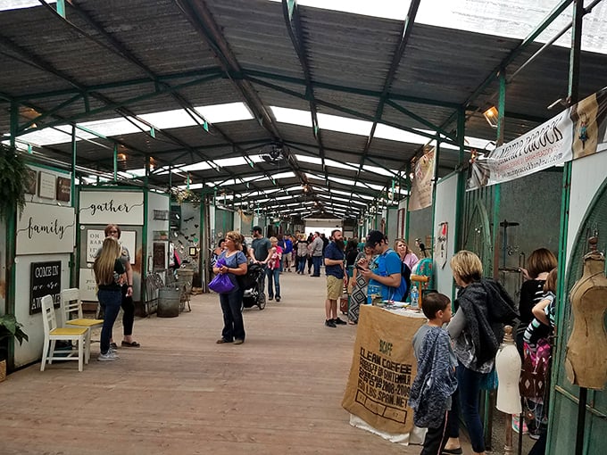 Bargain hunters navigate this covered marketplace like archaeologists, each booth a new dig site of potential discoveries.